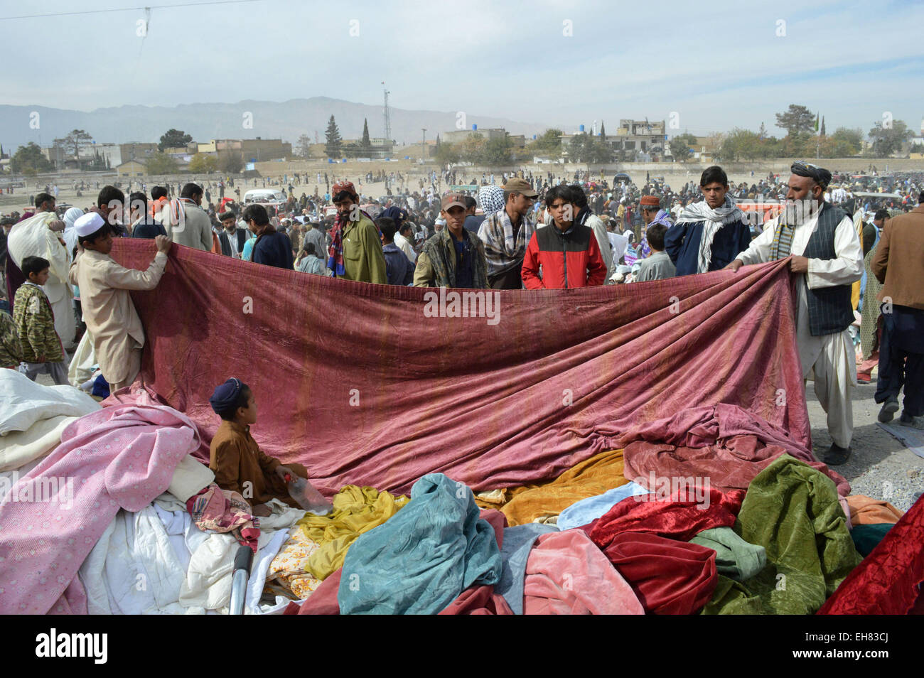 Quetta. 9th Mar, 2015. Pakistani people buy secondhand clothes from a ...