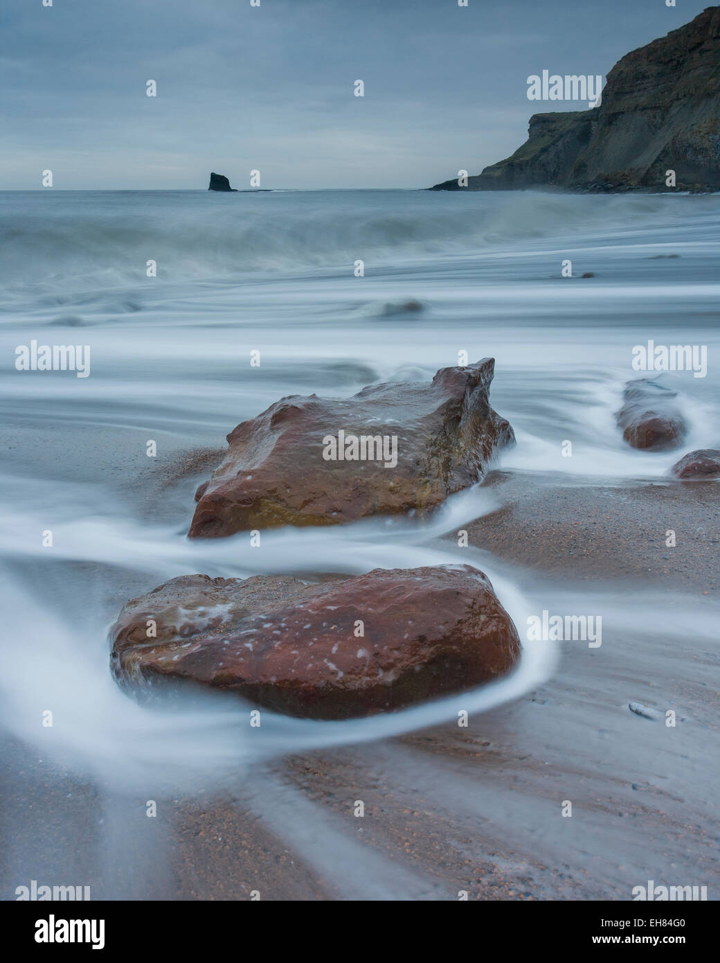 Swirling waves with a view towards the Black Nab sea stack at Saltwick ...