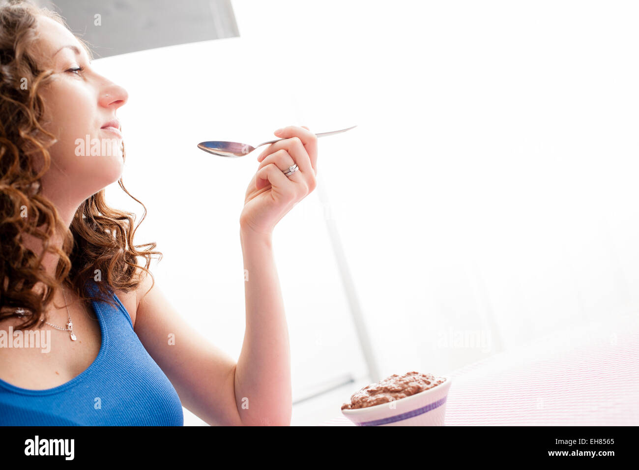 Woman eating chocolate pudding spoon hi-res stock photography and ...