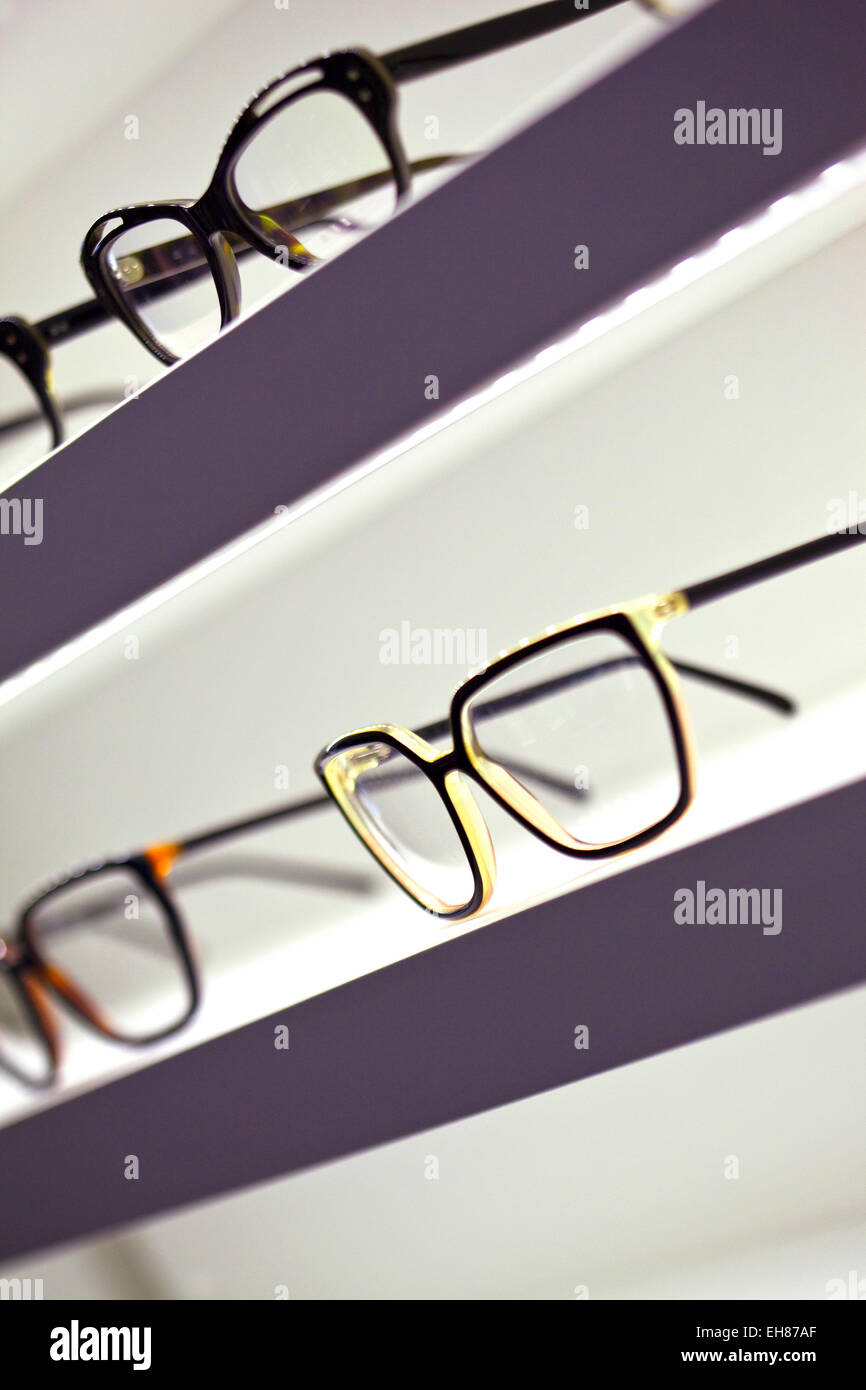 Glasses on shelves in an optical shop Stock Photo - Alamy
