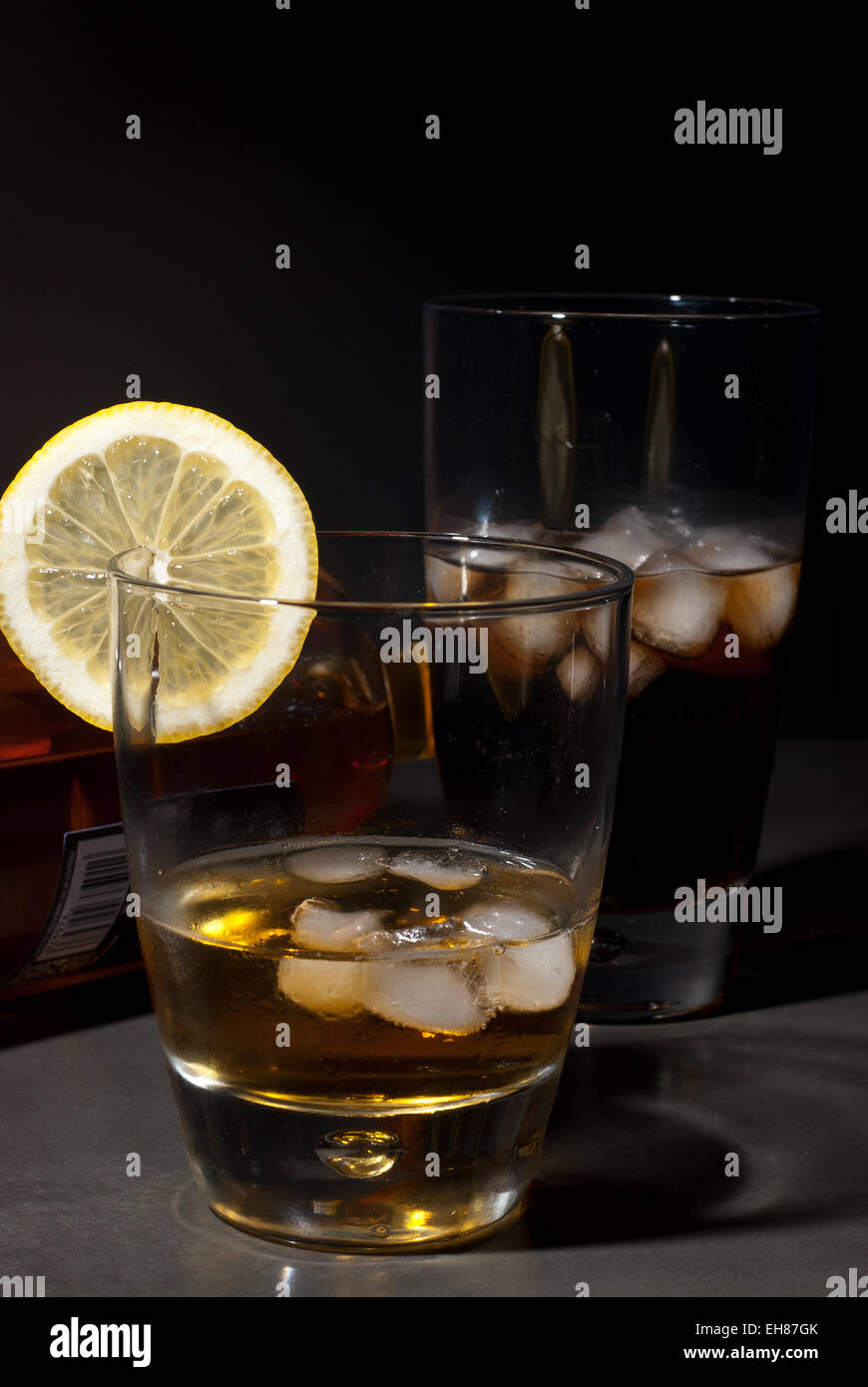 Whisky on the rocks and cola with ice cubes Stock Photo - Alamy