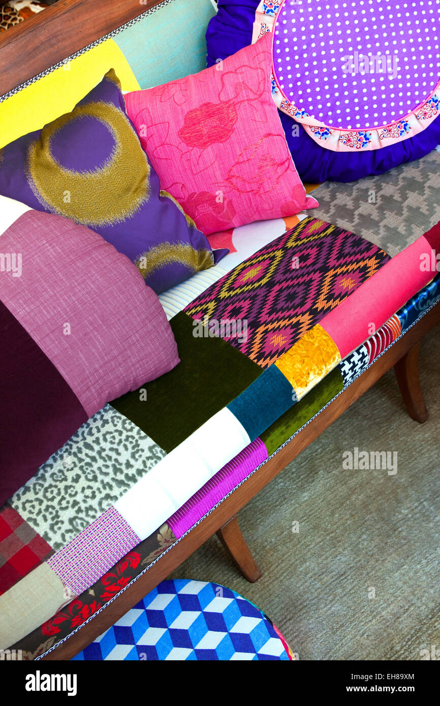 Patchwork of colorful cushions on a sofa Stock Photo - Alamy