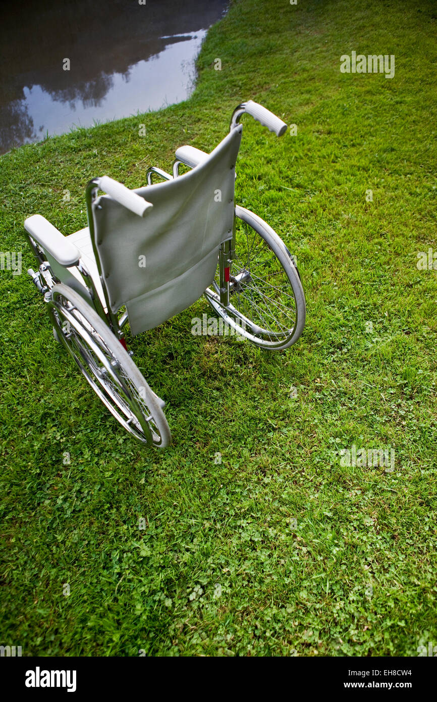 Wheelchair for disabled near a small lake Stock Photo - Alamy