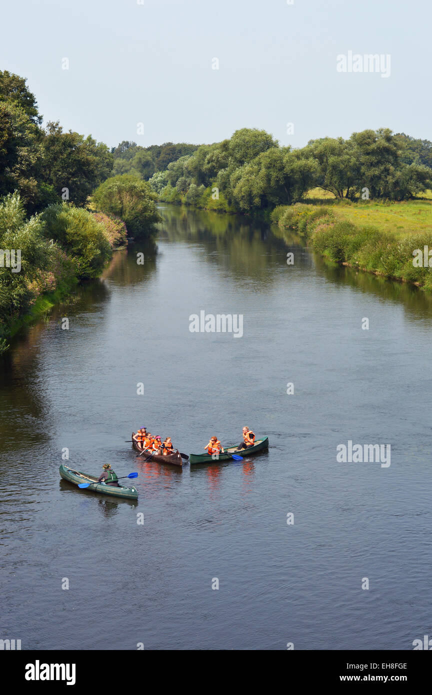 LINGEN, GERMANY - AUGUST 2013: Youth paddling in canoes on the Ems ...