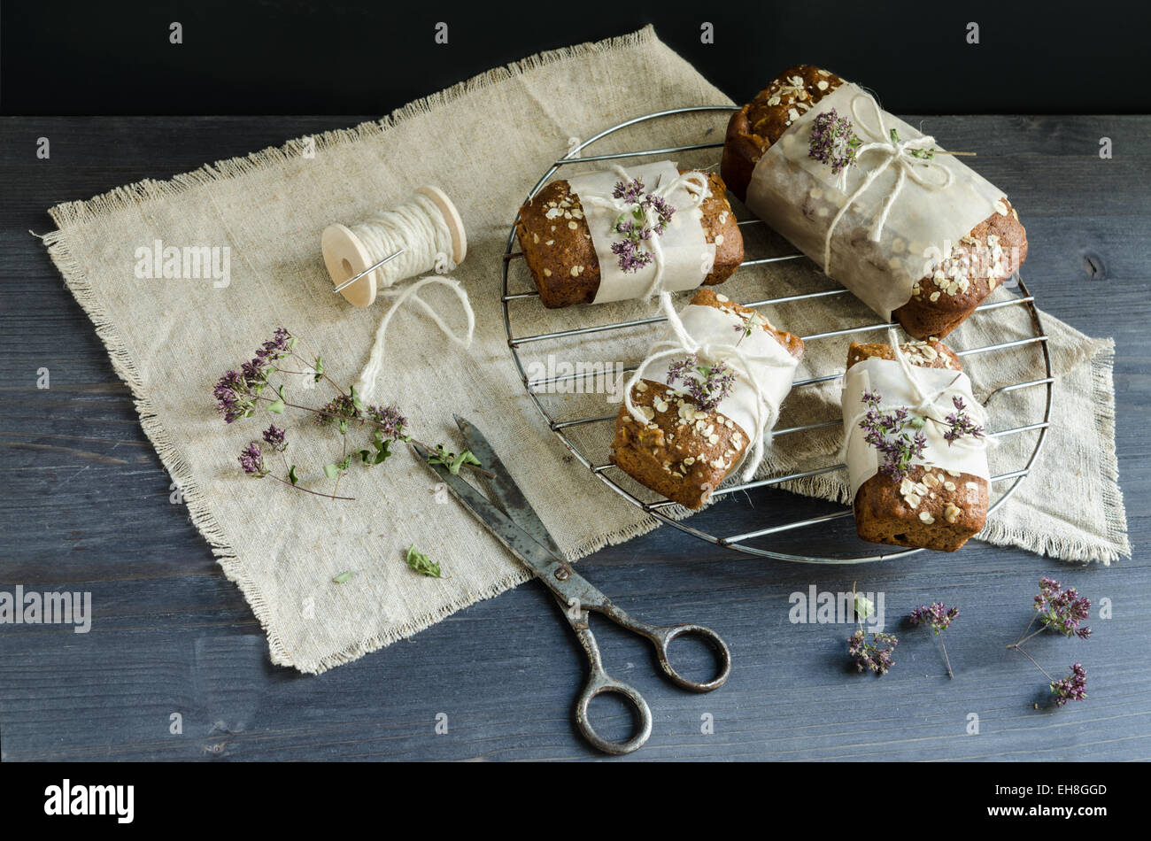 Homemade bread with apples in wrapping paper on grid Stock Photo - Alamy
