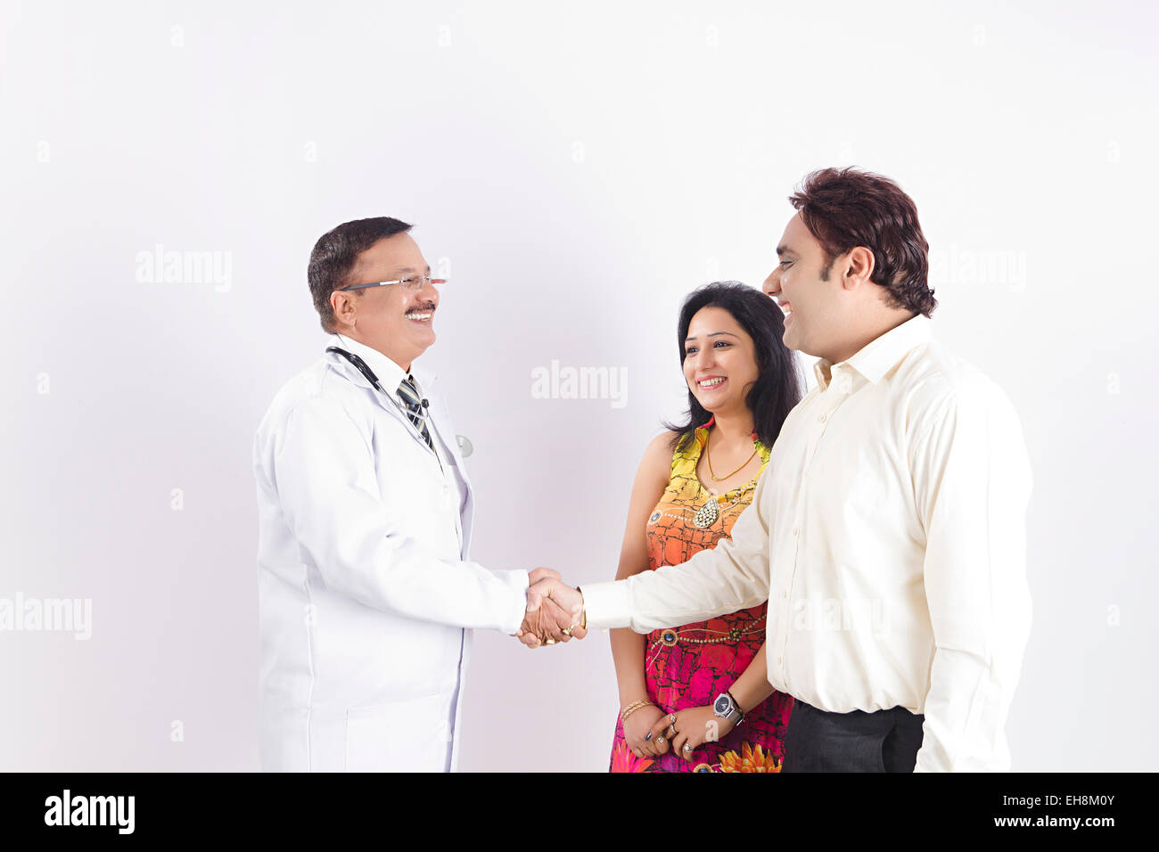 3 indian people doctor and Married Couple Health Treatment Shaking Hand ...