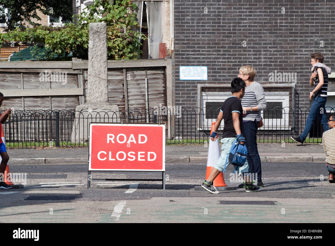 Spectators wait by a Road Closed sign in expectation of the Hackney ...