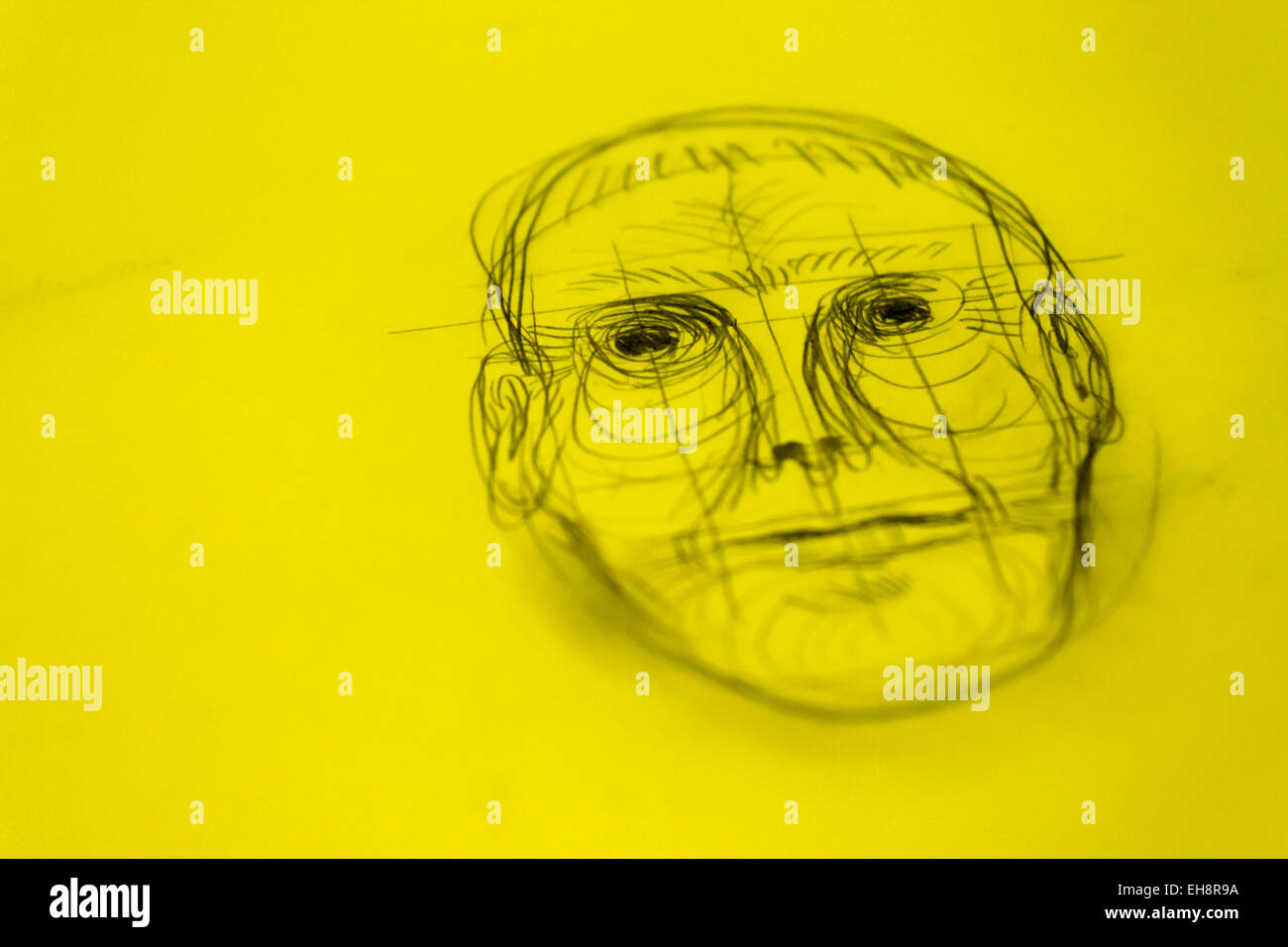 Drawn face in yellow background Stock Photo - Alamy