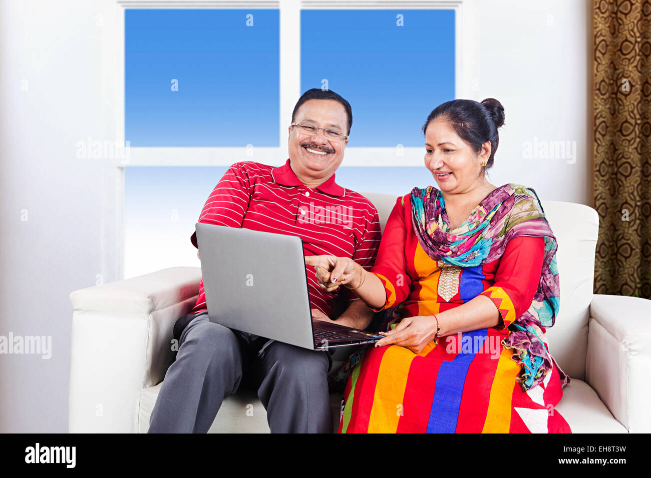 Cheerful indian couple watching laptop hi-res stock photography and ...