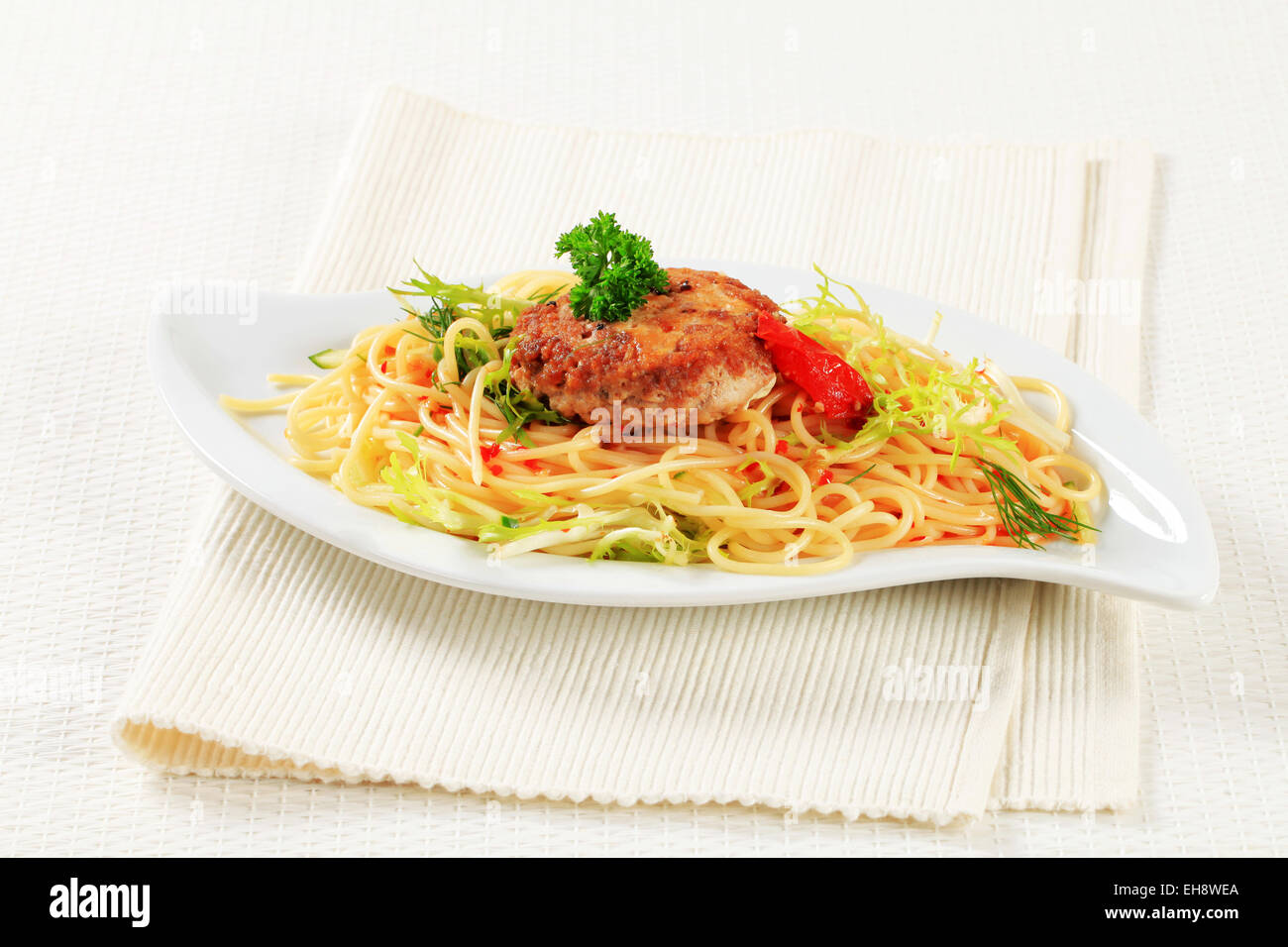 Meat patty with spaghetti and spicy sauce Stock Photo - Alamy