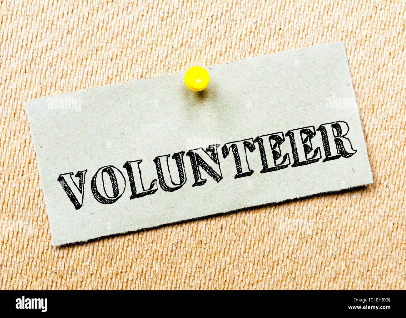 Recycled paper note pinned on cork board. Volunteer Message. Concept ...