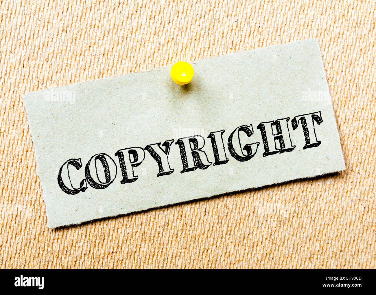 Recycled paper note pinned on cork board. Copyright Message. Concept ...