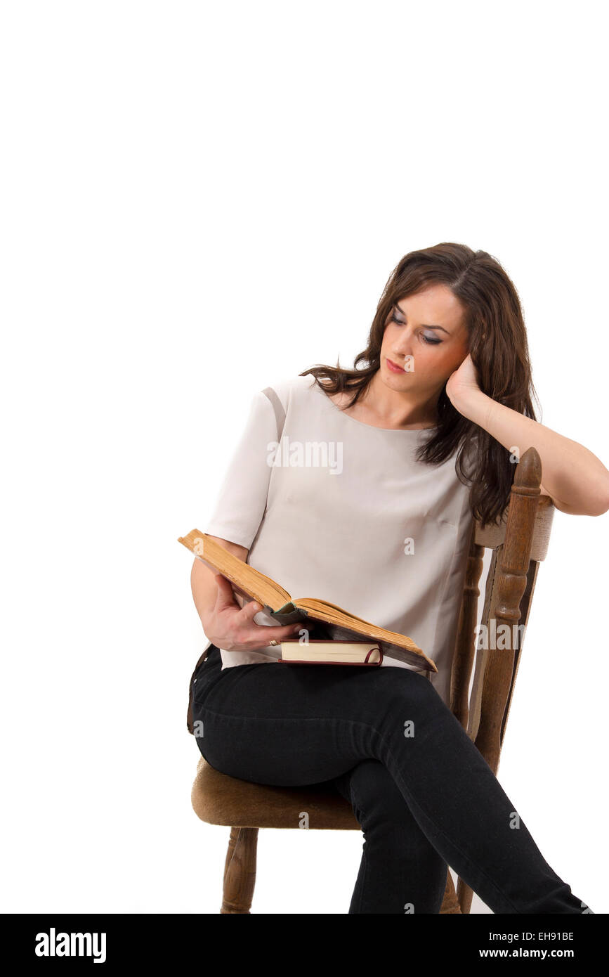 beautiful woman sitting on a chair and reading a book Stock Photo - Alamy