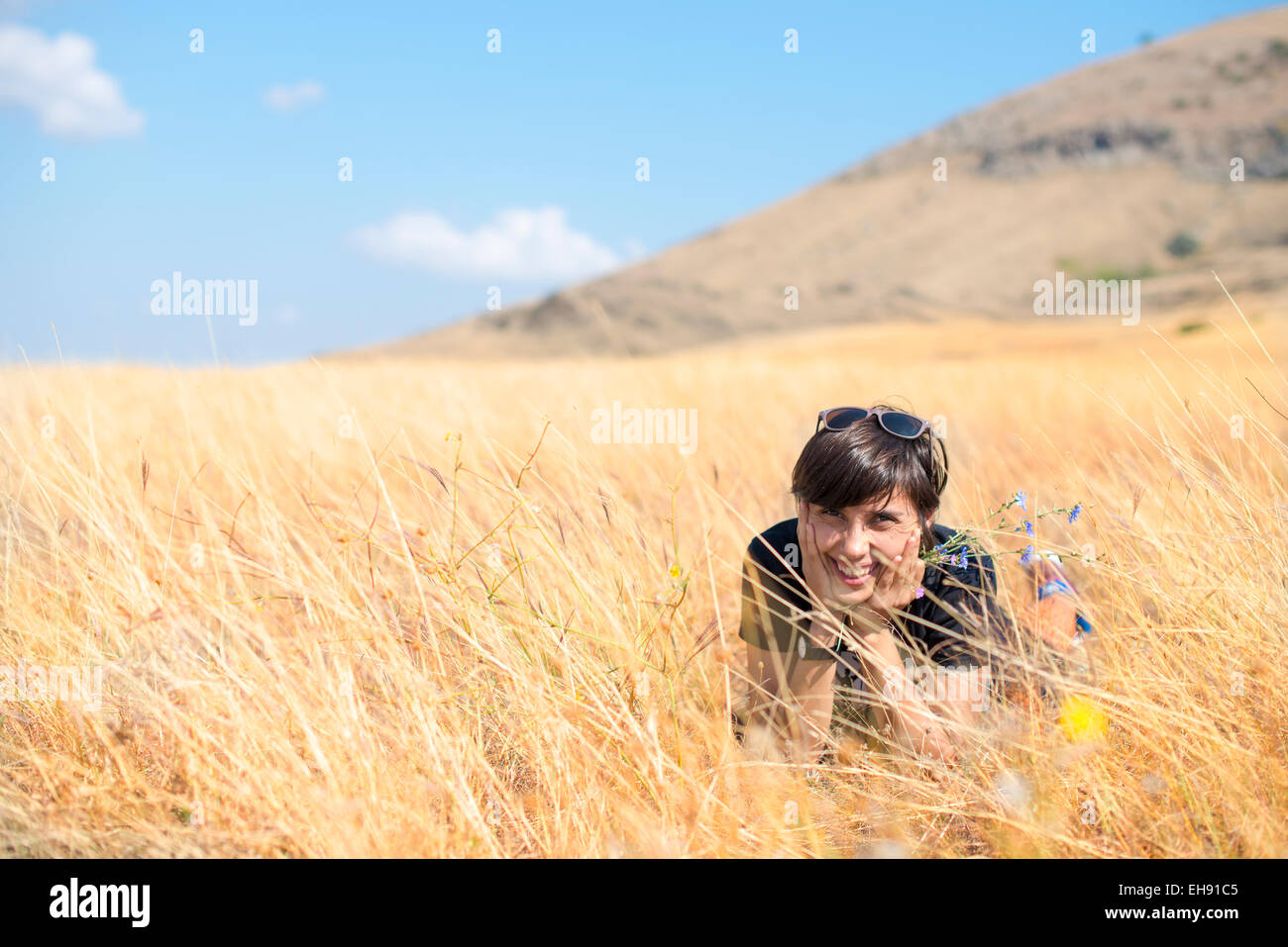 beautiful Young woman lying on hay Stock Photo - Alamy