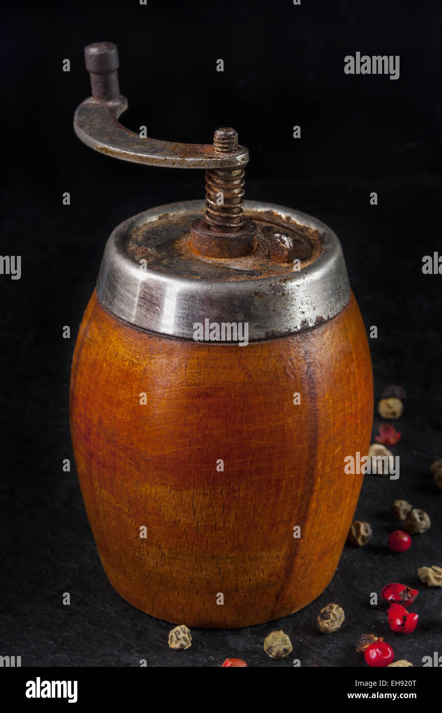 Vintage pepper mill on black stone table Stock Photo - Alamy