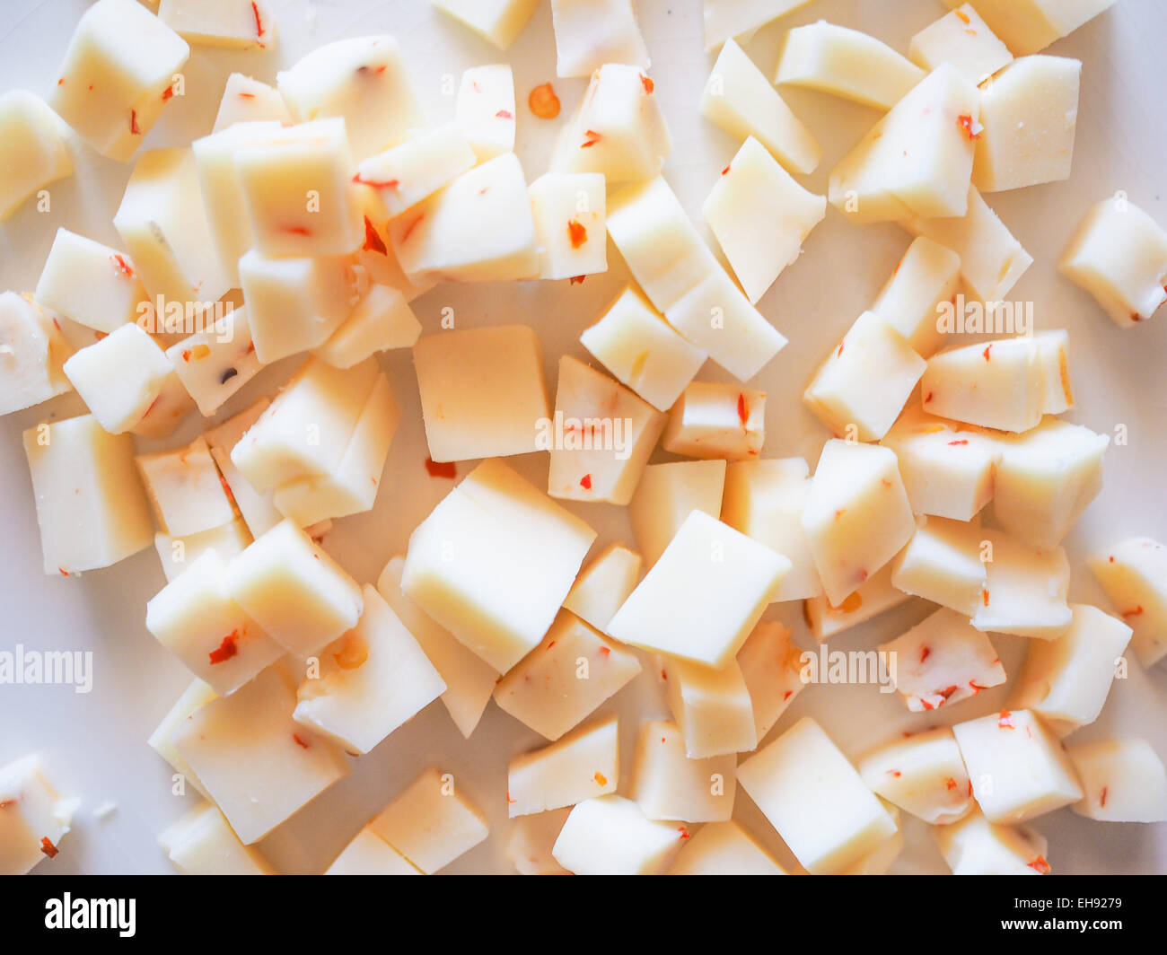Diced cheese with red hot chilli peppers Stock Photo - Alamy