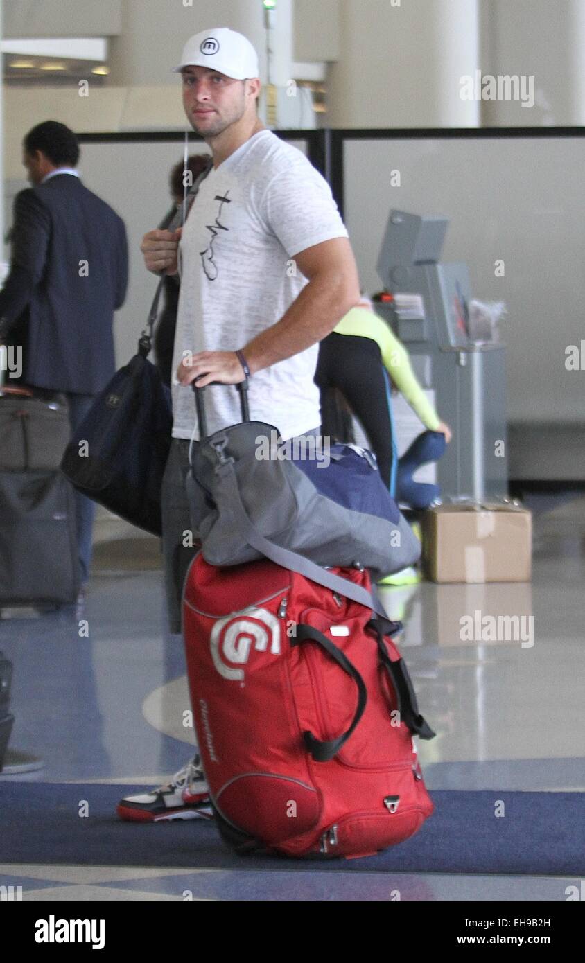Tim Tebow waits to check in at Los Angeles International (LAX) airport ...
