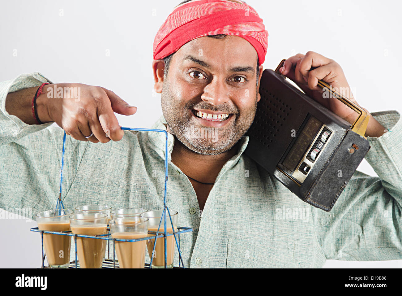 1 indian man Tea Servant hearing FM Radio Stock Photo - Alamy