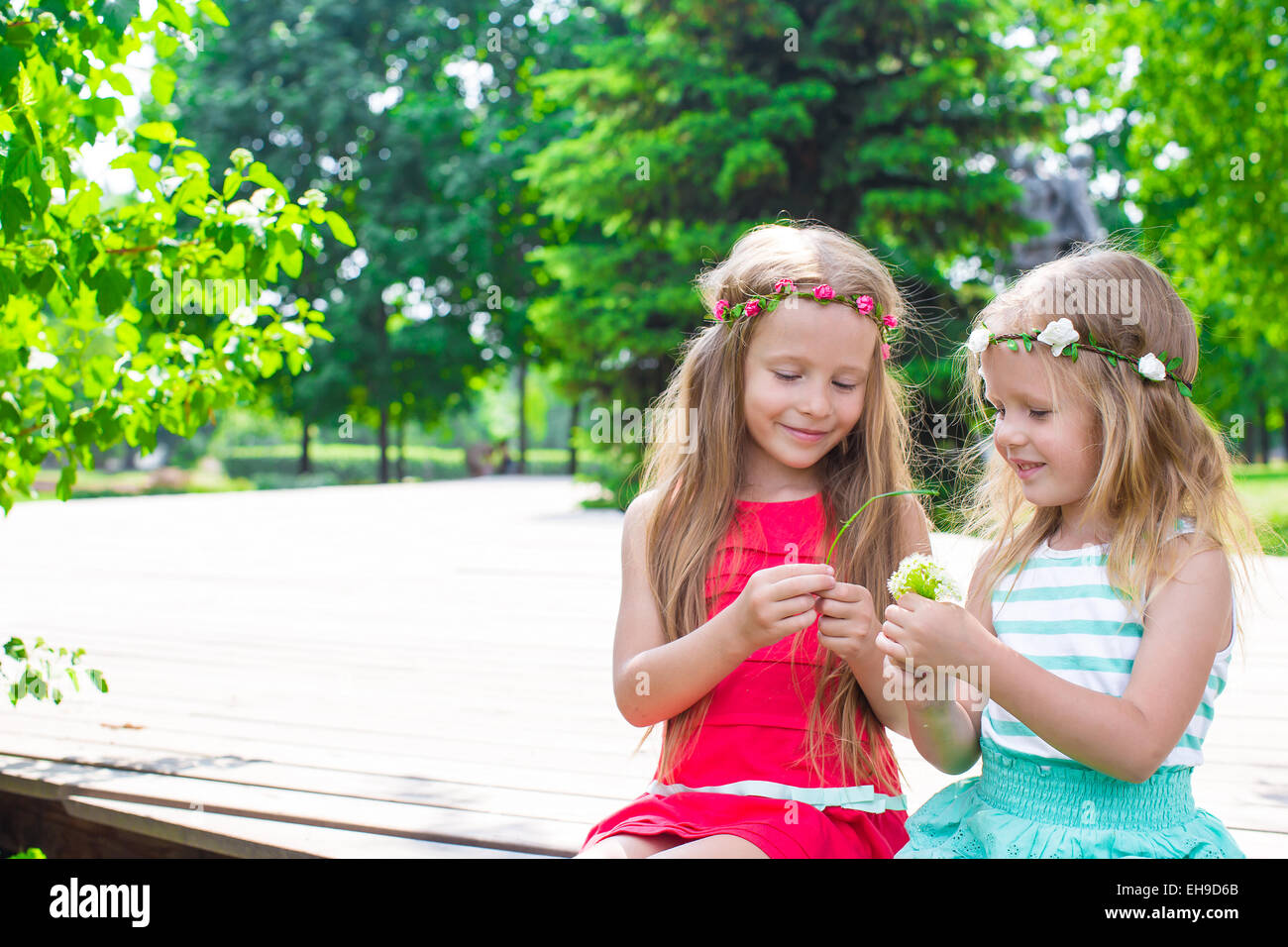 Adorable little girls enjoying warm summer day Stock Photo - Alamy