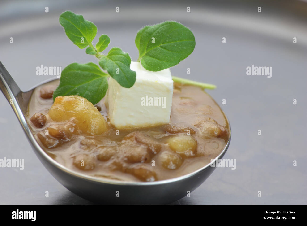 Ladle of lentil soup with feta cheese cubes and fresh oregano Stock ...