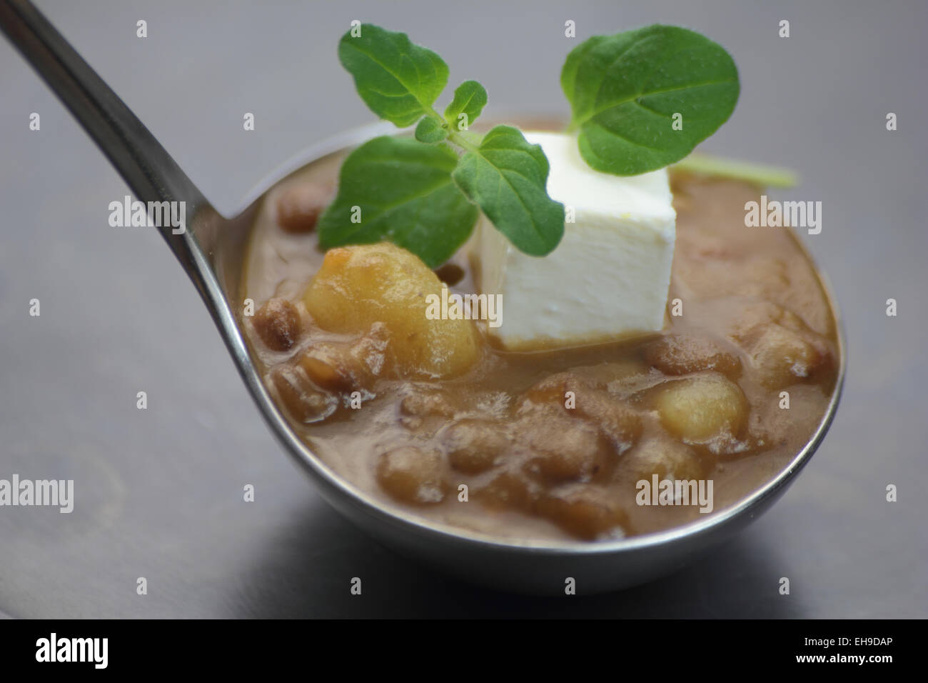 Ladle of lentil soup with feta cheese cubes and fresh oregano Stock ...