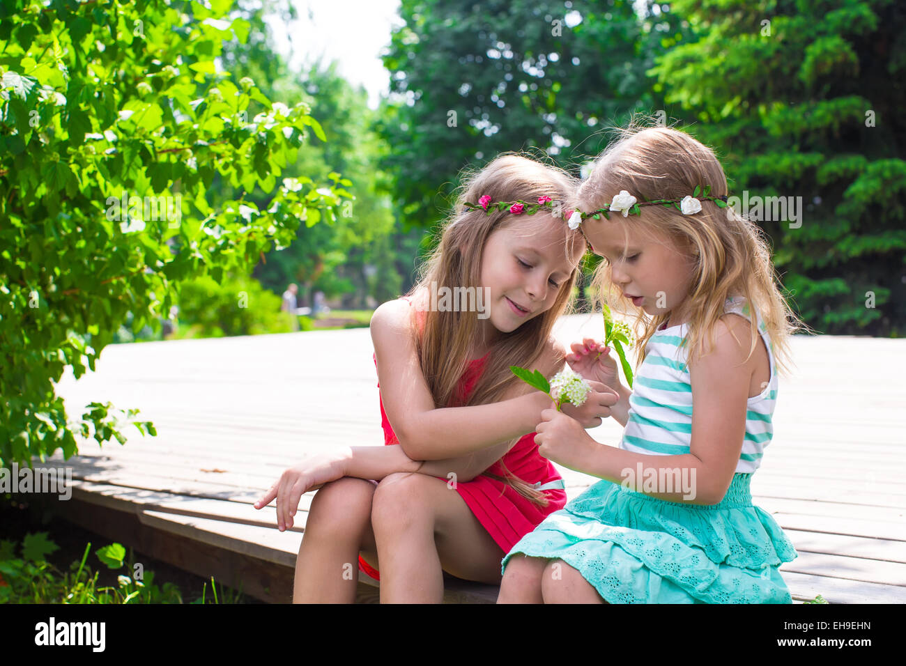 Happy adorable little girls enjoying warm summer day Stock Photo - Alamy