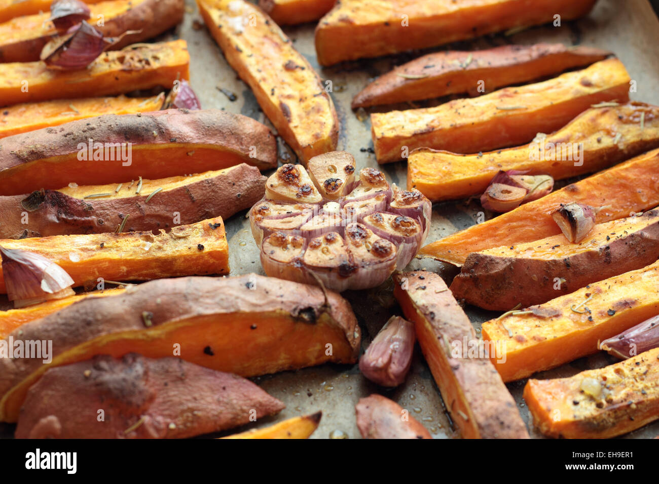 Sweet potato roasted chips just taken from the oven Stock Photo - Alamy