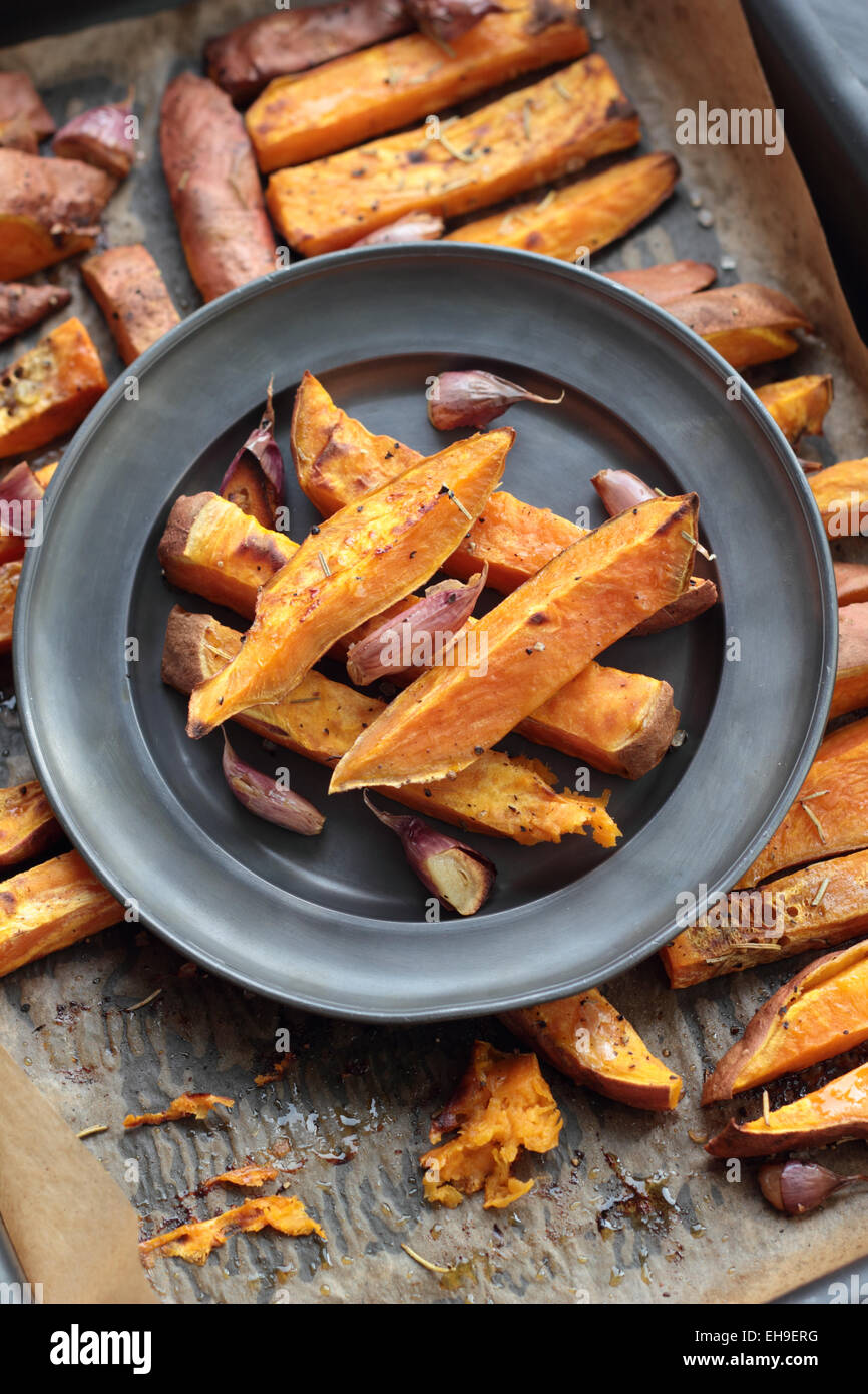 Sweet potato roasted chips on a tin plate Stock Photo - Alamy
