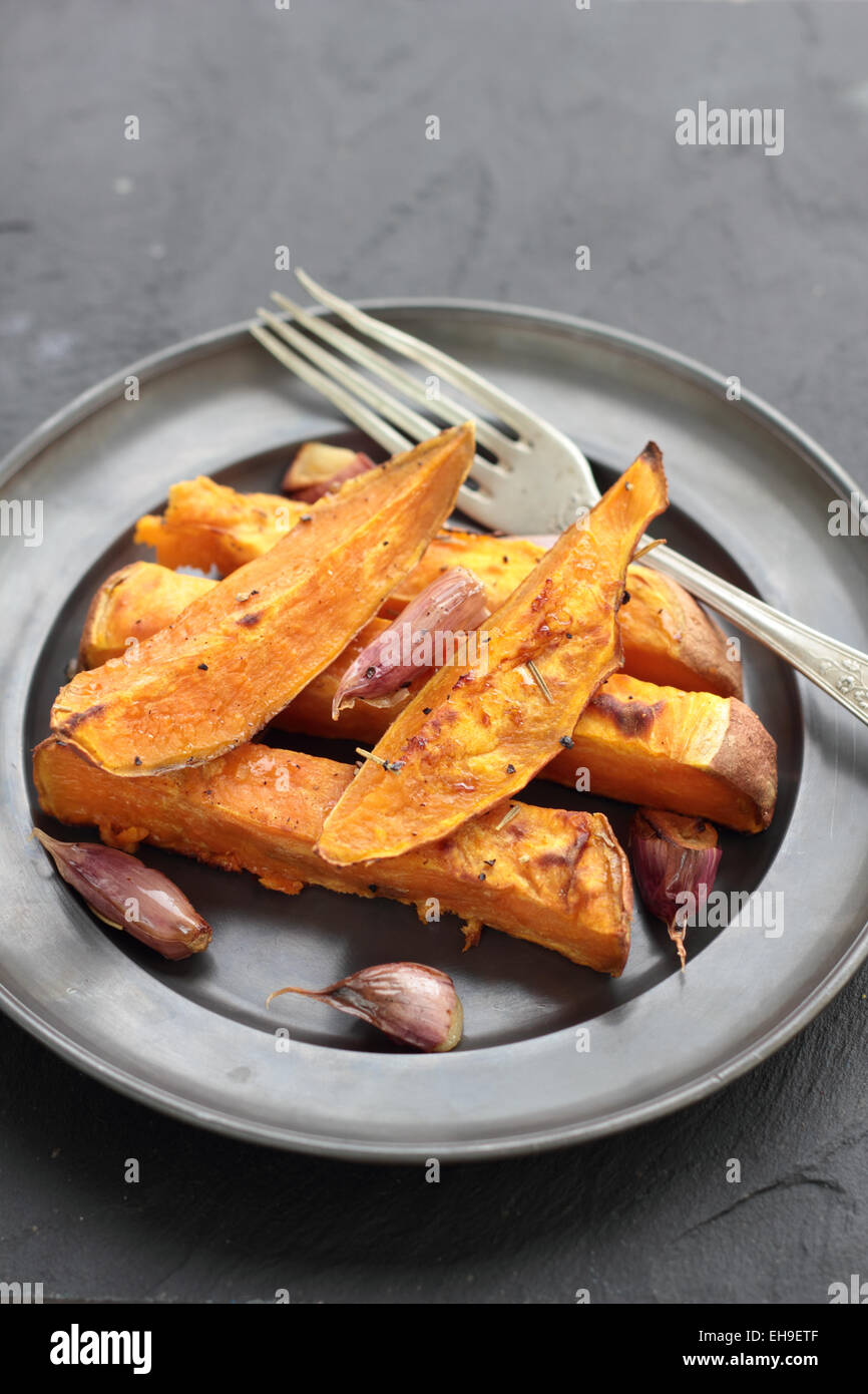 Sweet potato roasted chips on a tin plate Stock Photo - Alamy