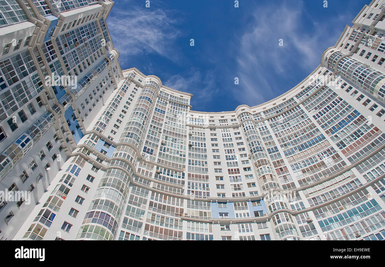 Modern high-rise residential house on a blue sky background Stock Photo ...