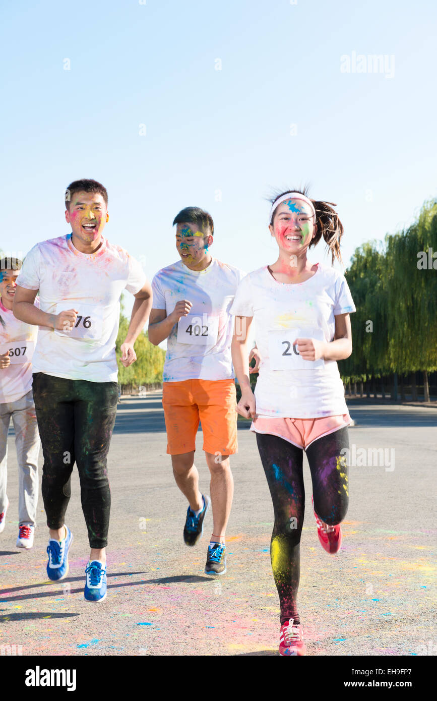 Young woman leading at The Color Run Stock Photo - Alamy
