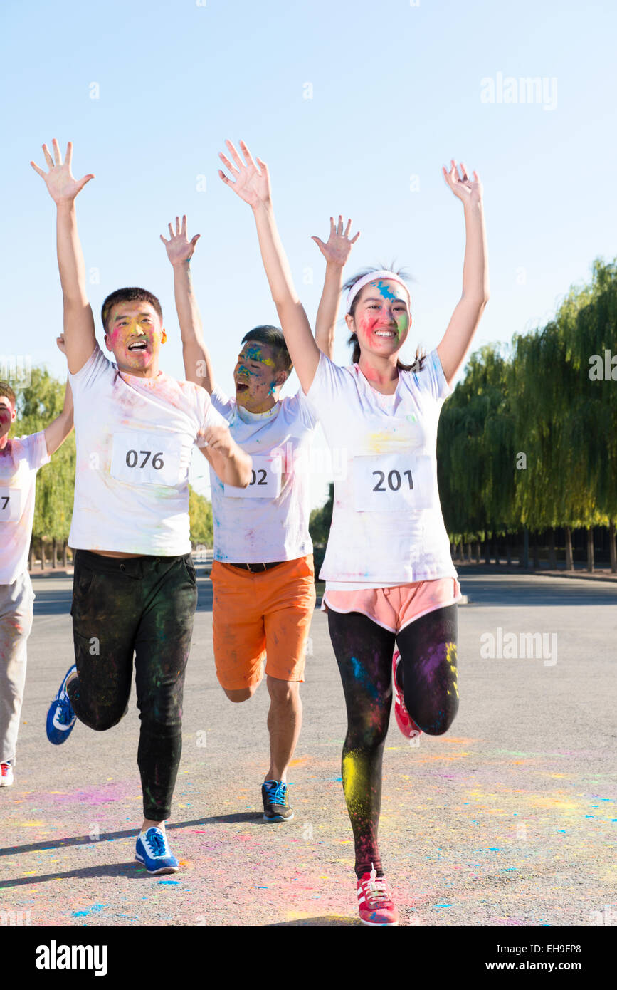 Young woman leading at The Color Run Stock Photo - Alamy