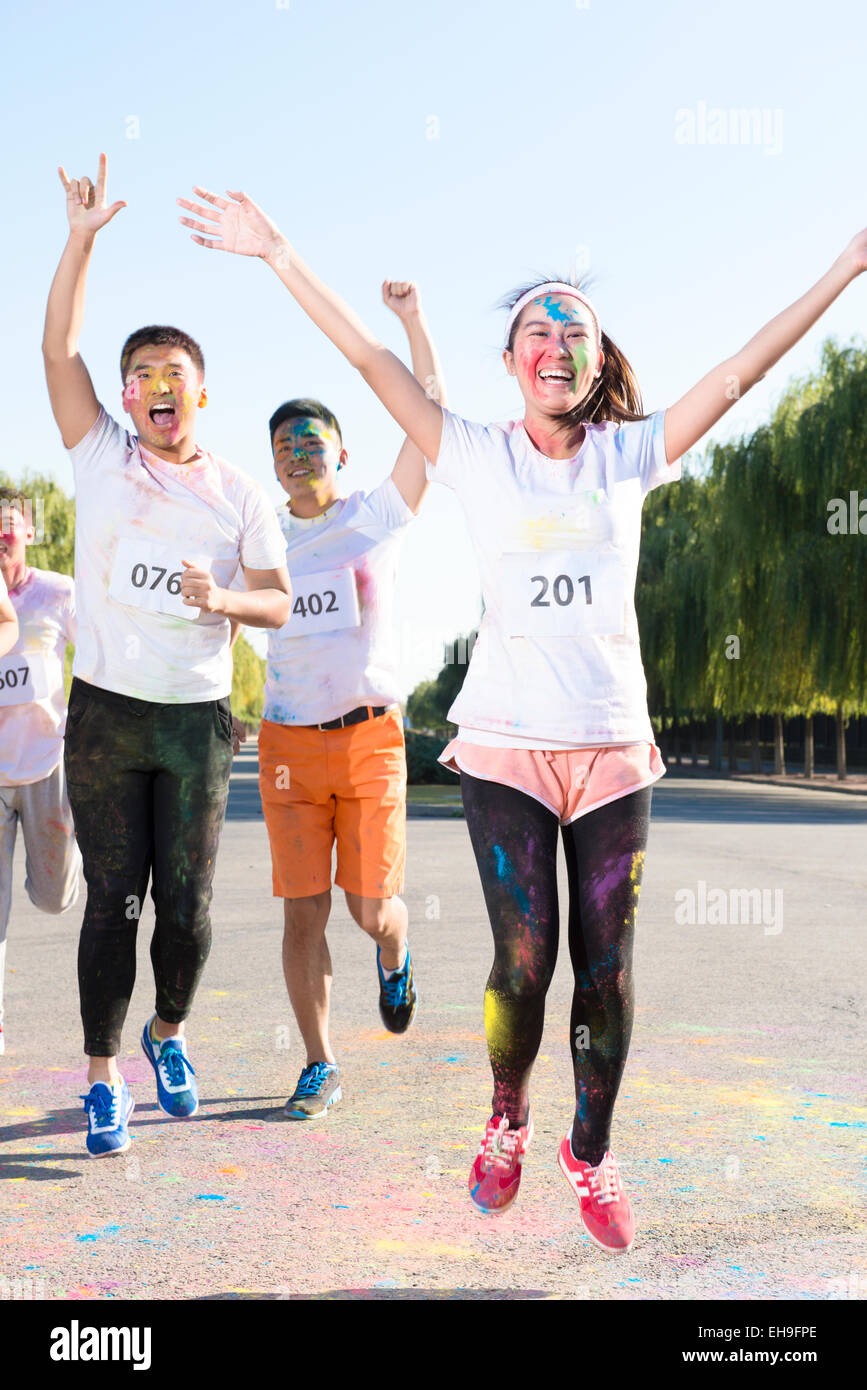 Young woman leading at The Color Run Stock Photo - Alamy
