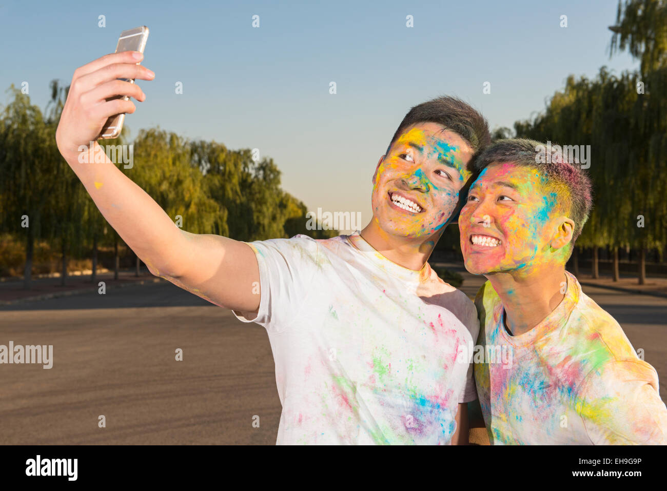 Friends taking selfie at The Color Run Stock Photo - Alamy