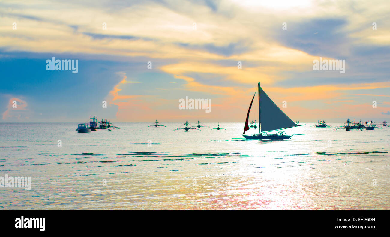 Sailing boat at beautiful colorful sunset Stock Photo - Alamy