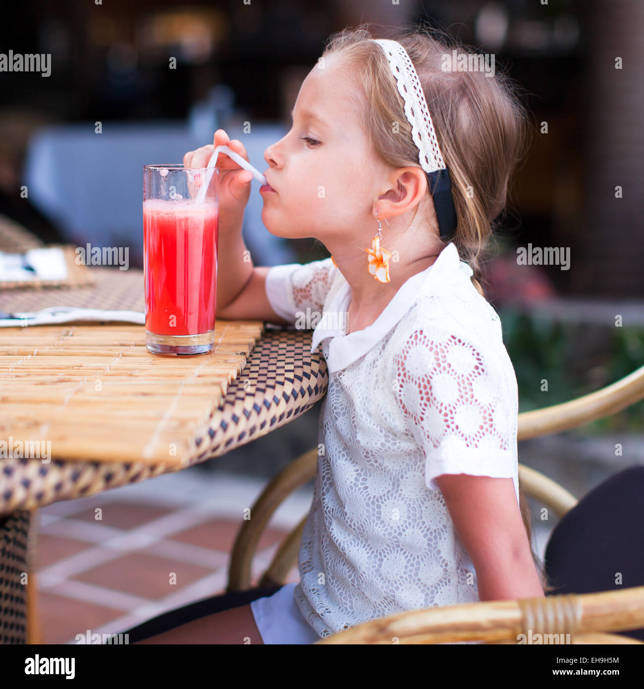Adorable little girl drinking fruit cocktail outdoor Stock Photo - Alamy