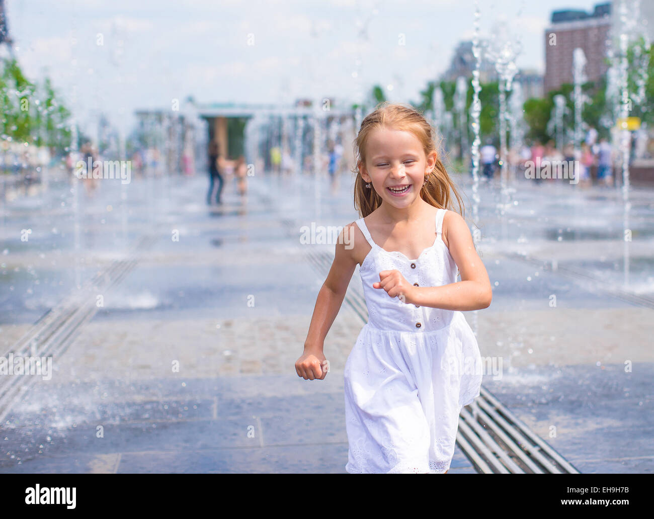 Little happy girl have fun in outdoor fountain at hot day Stock Photo ...
