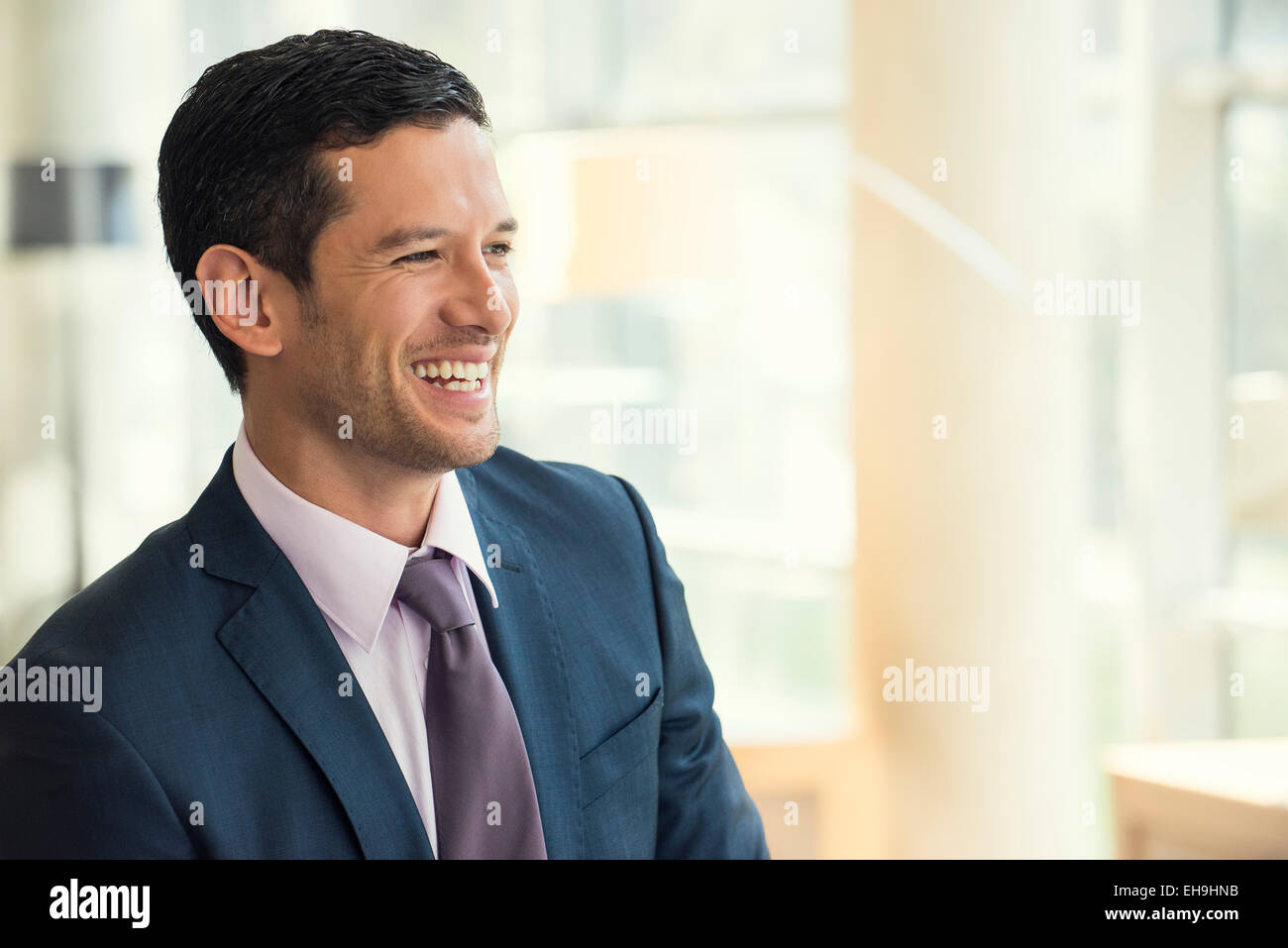 Businessman smiling cheerfully Stock Photo - Alamy