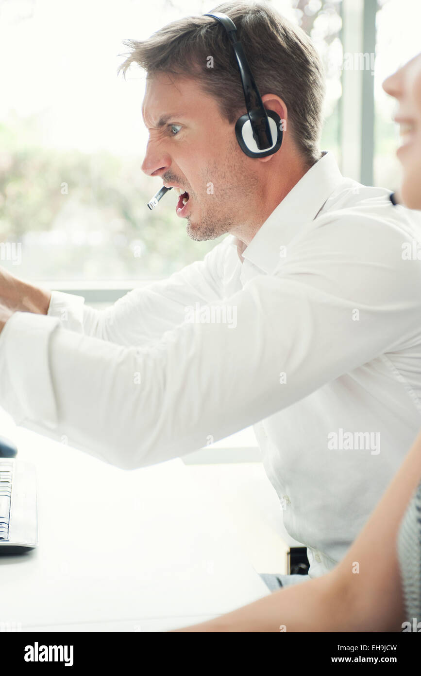 Frustrated call center worker Stock Photo - Alamy