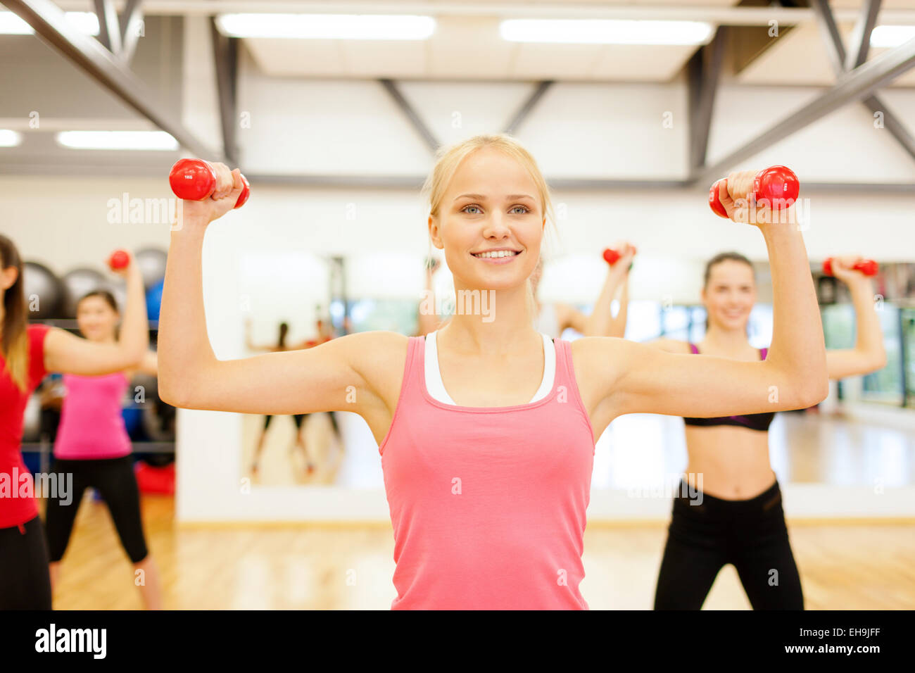 group of smiling people working out with dumbbells Stock Photo - Alamy