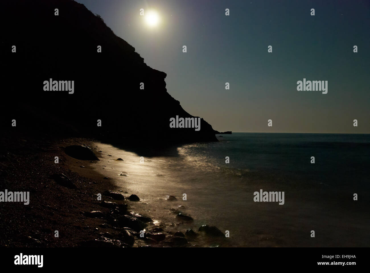 Moon night on the sea with waves and rocks Stock Photo - Alamy
