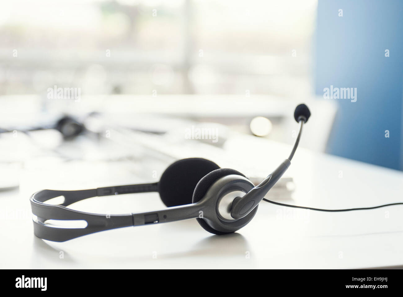 Phone headset on desk Stock Photo - Alamy
