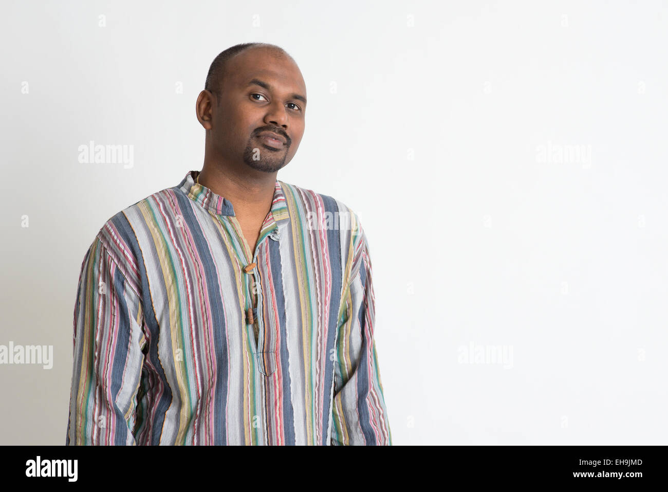 Portrait of cool Indian man on plain background with shadow Stock Photo ...