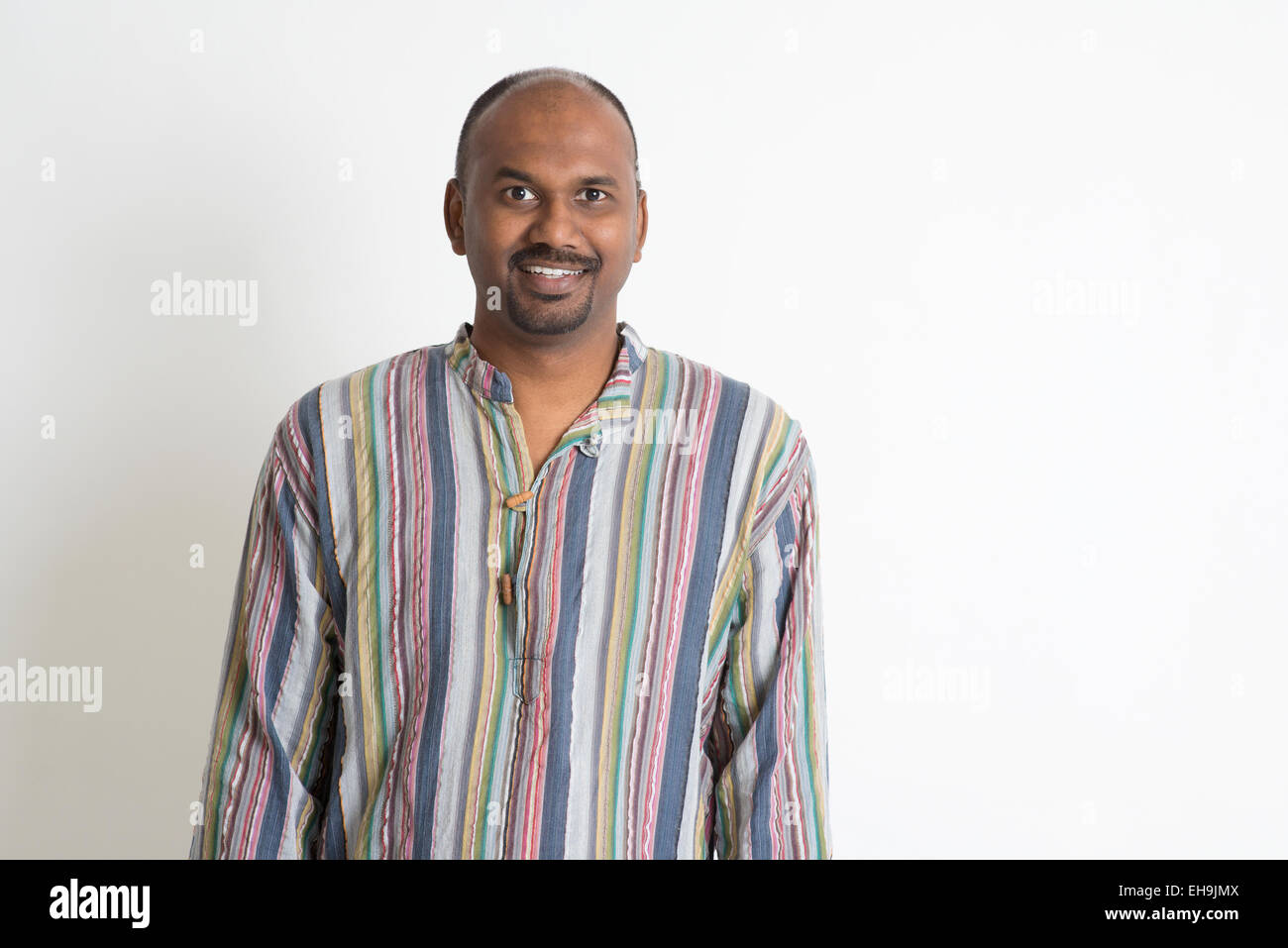 Portrait of smiling Indian man on plain background with shadow Stock ...