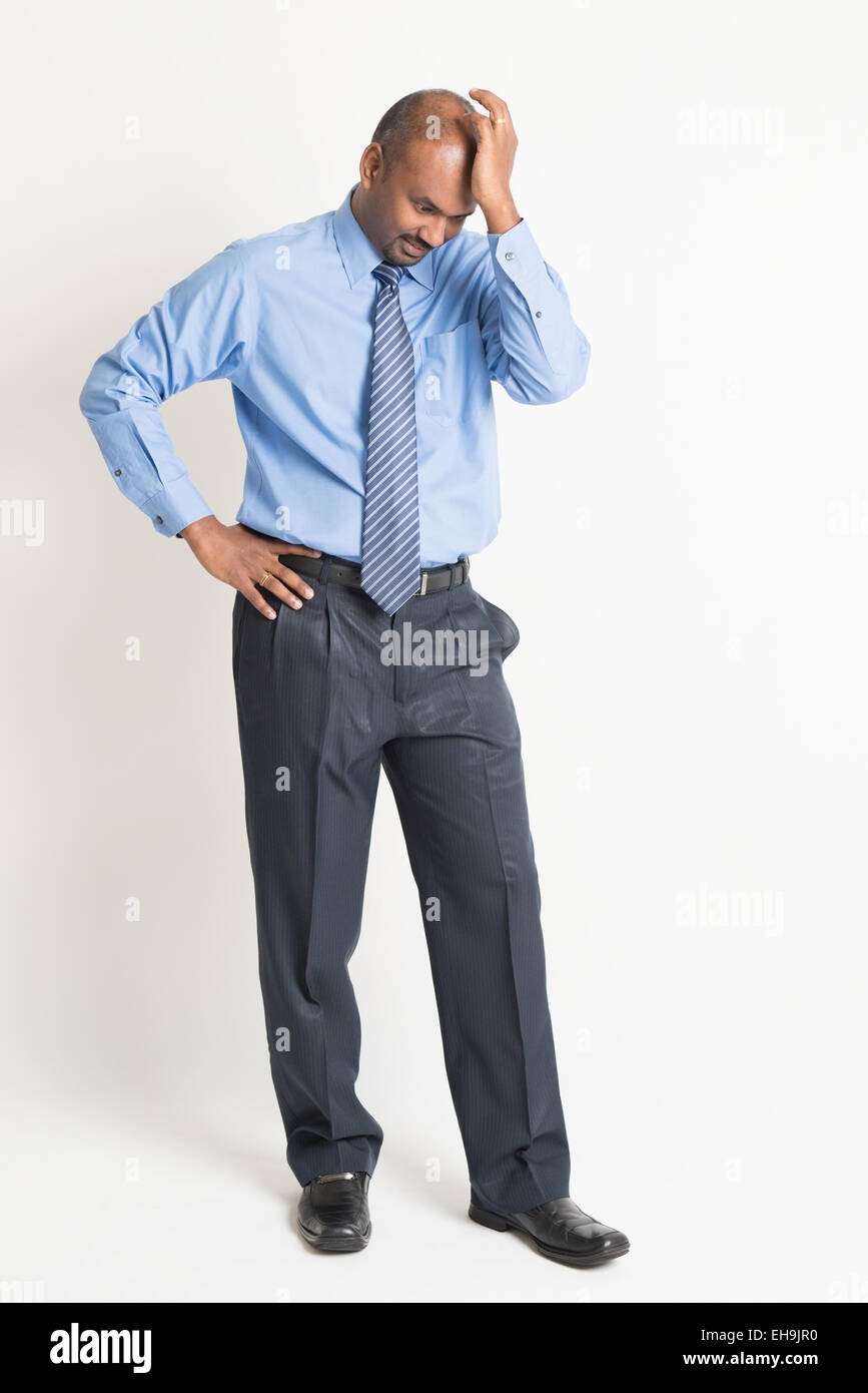 Full length Indian businessman hitting his head with hand, standing on ...