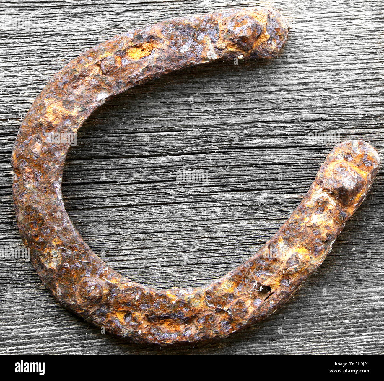vintage rusted horseshoe on wall above door Stock Photo - Alamy