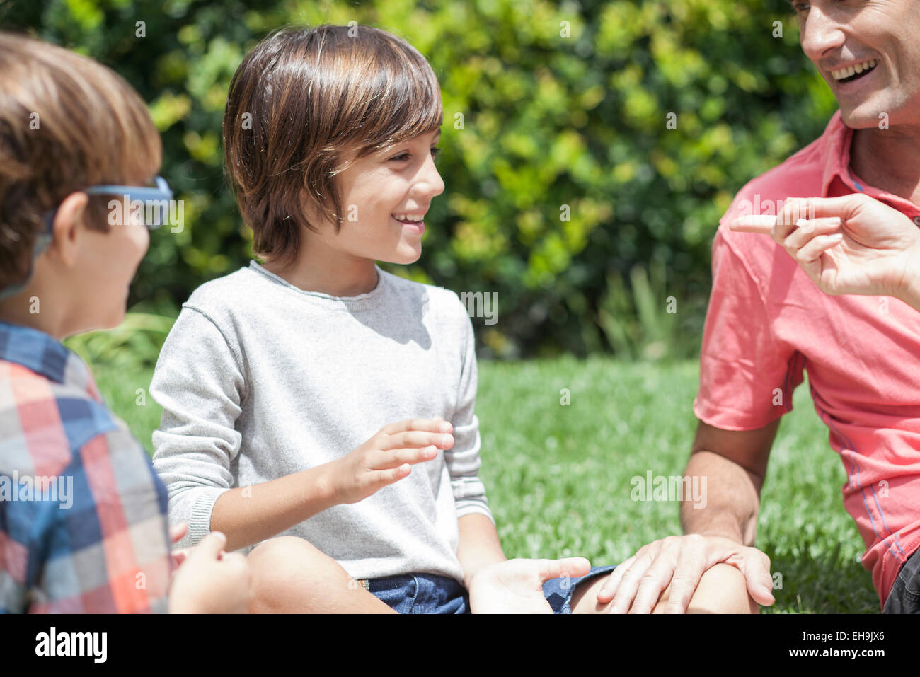 Young boys enjoying outdoor recreation with parents Stock Photo - Alamy