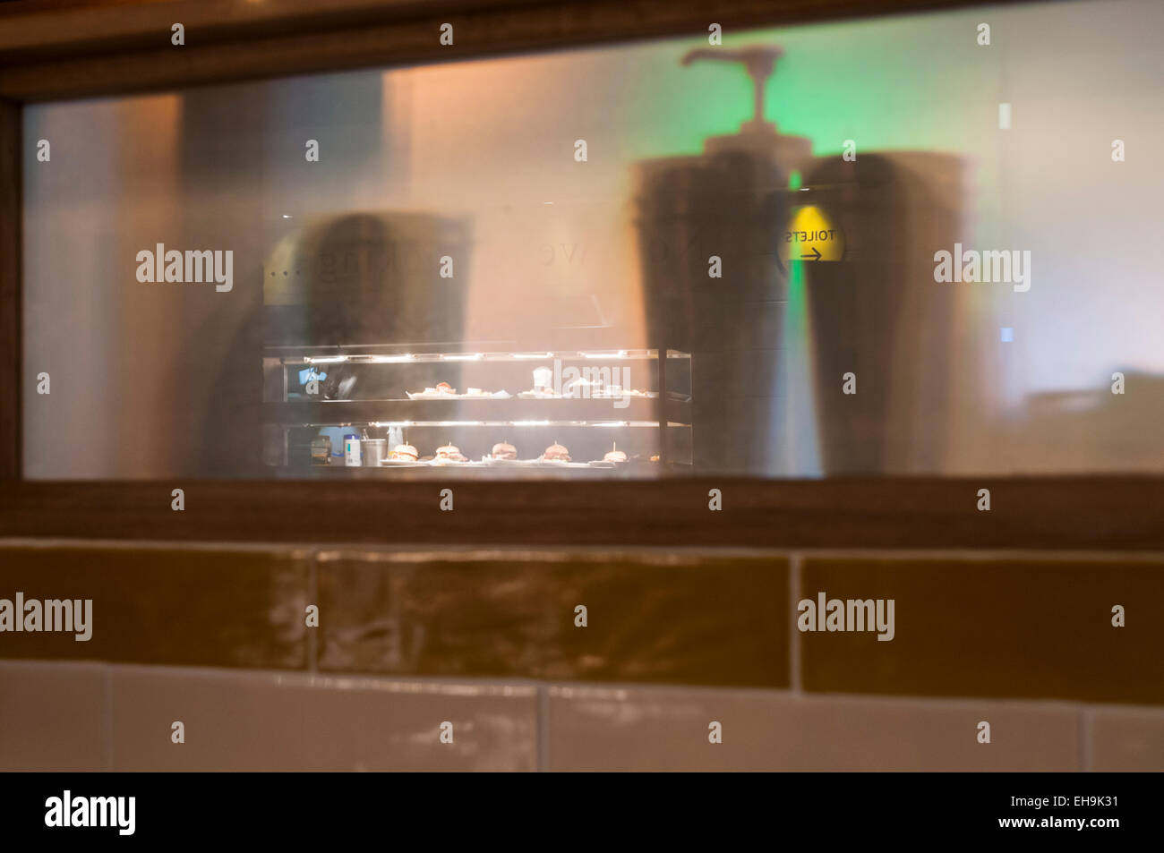 Abstract reflection of food awaiting collection from the kitchen in a ...