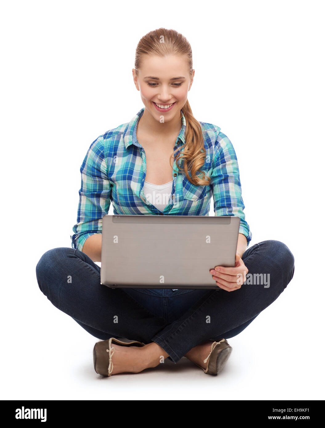 smiling woman with laptop sitting on floor Stock Photo - Alamy