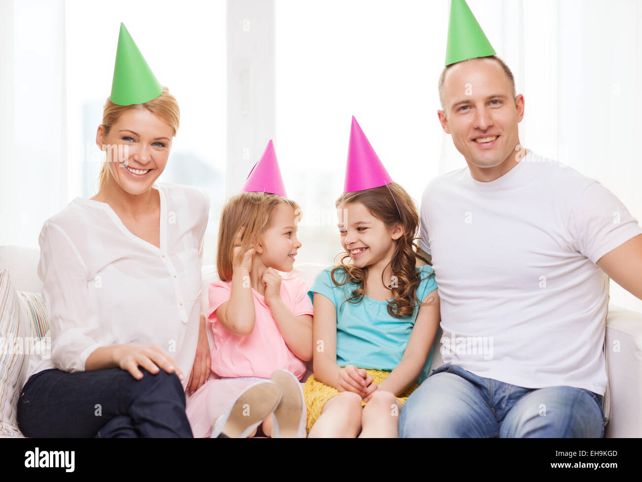 happy family with two kids in hats celebrating Stock Photo - Alamy